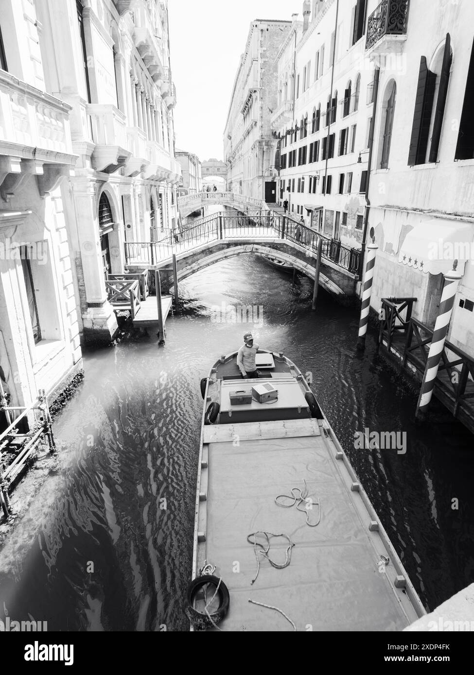 Venice, Italy - June 30th 20220 Delivery man standing on a barge ...