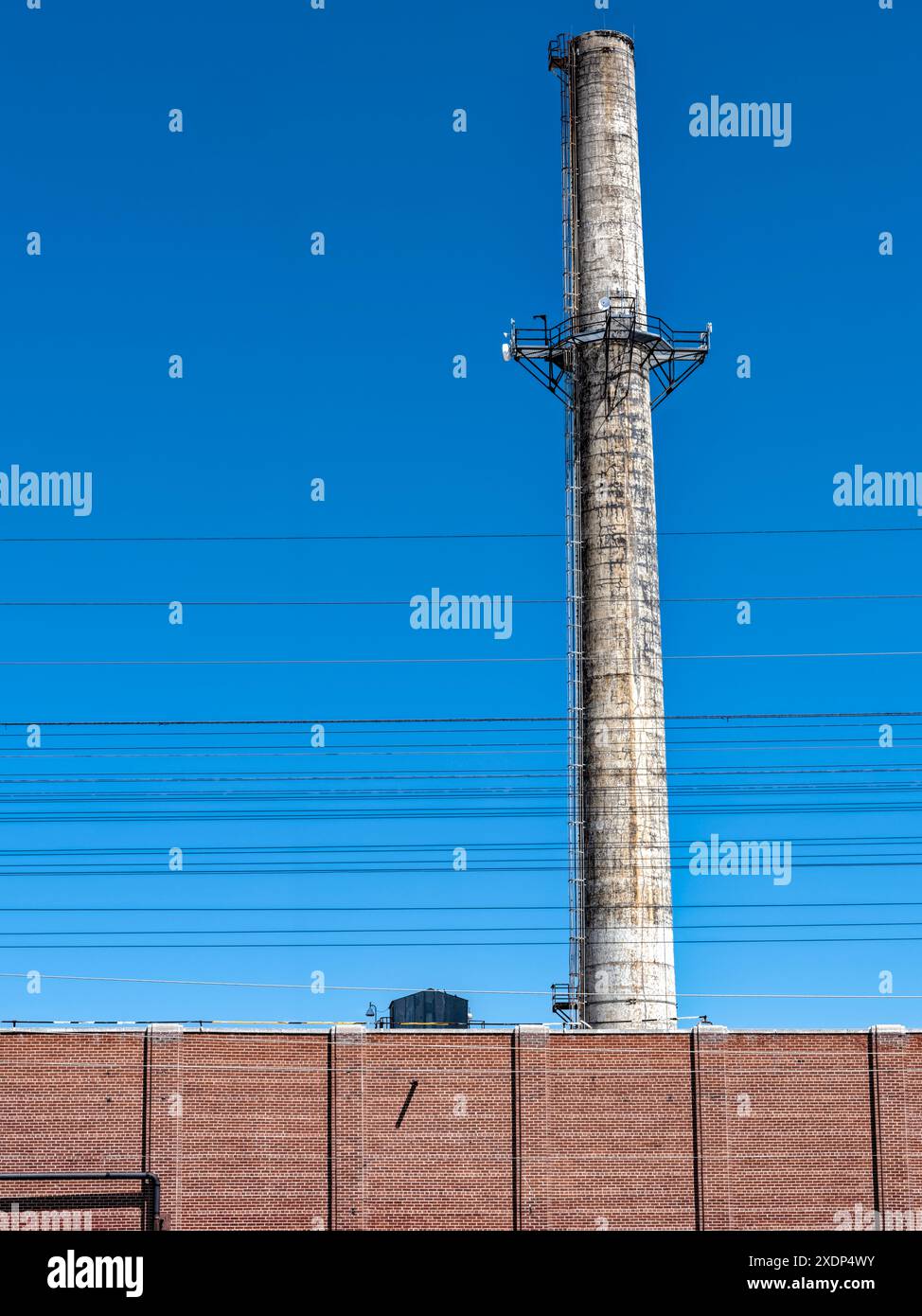 Tall concrete smokestack with a cage ladder and center platform Stock ...