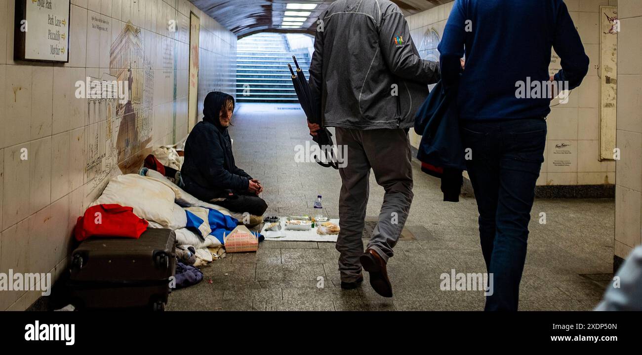 Homeless person begging in subway under Hyde Park Corner , London ...