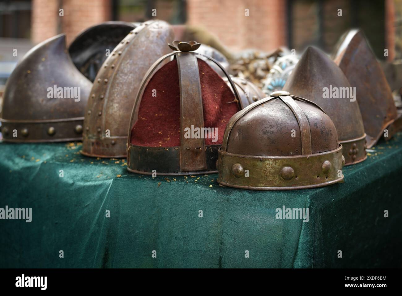 Various old rusty helmets made of metal based on historical models for ...