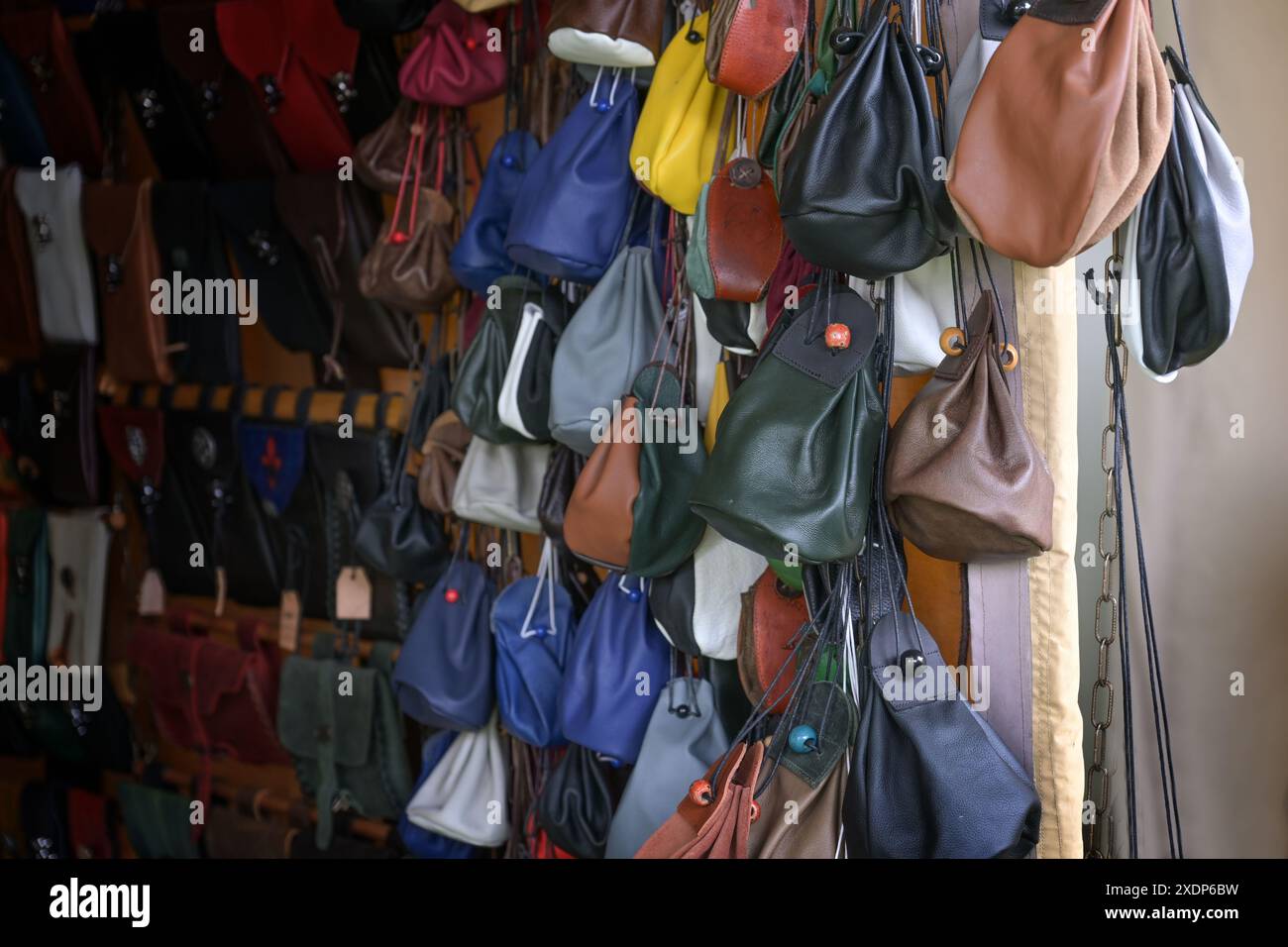 Leather pouches in various colors for sale in a stall at a medieval ...