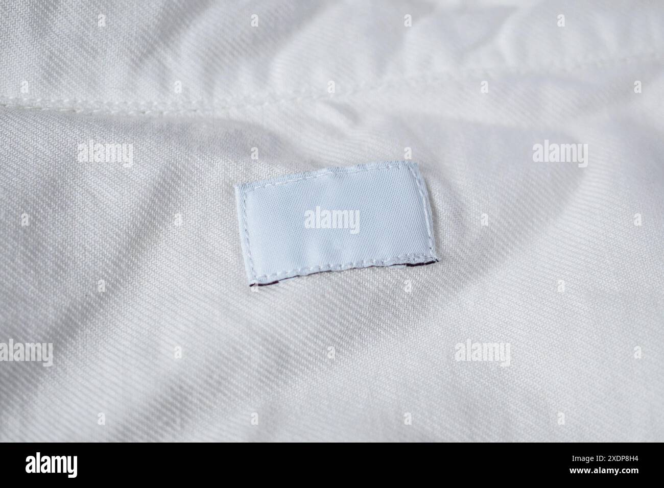 White blank laundry care clothes label on cotton shirt Stock Photo - Alamy