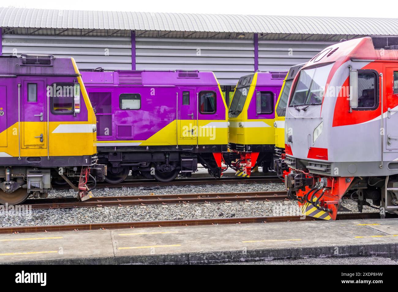 Head locomotive side view of the station platform and commuter train in ...