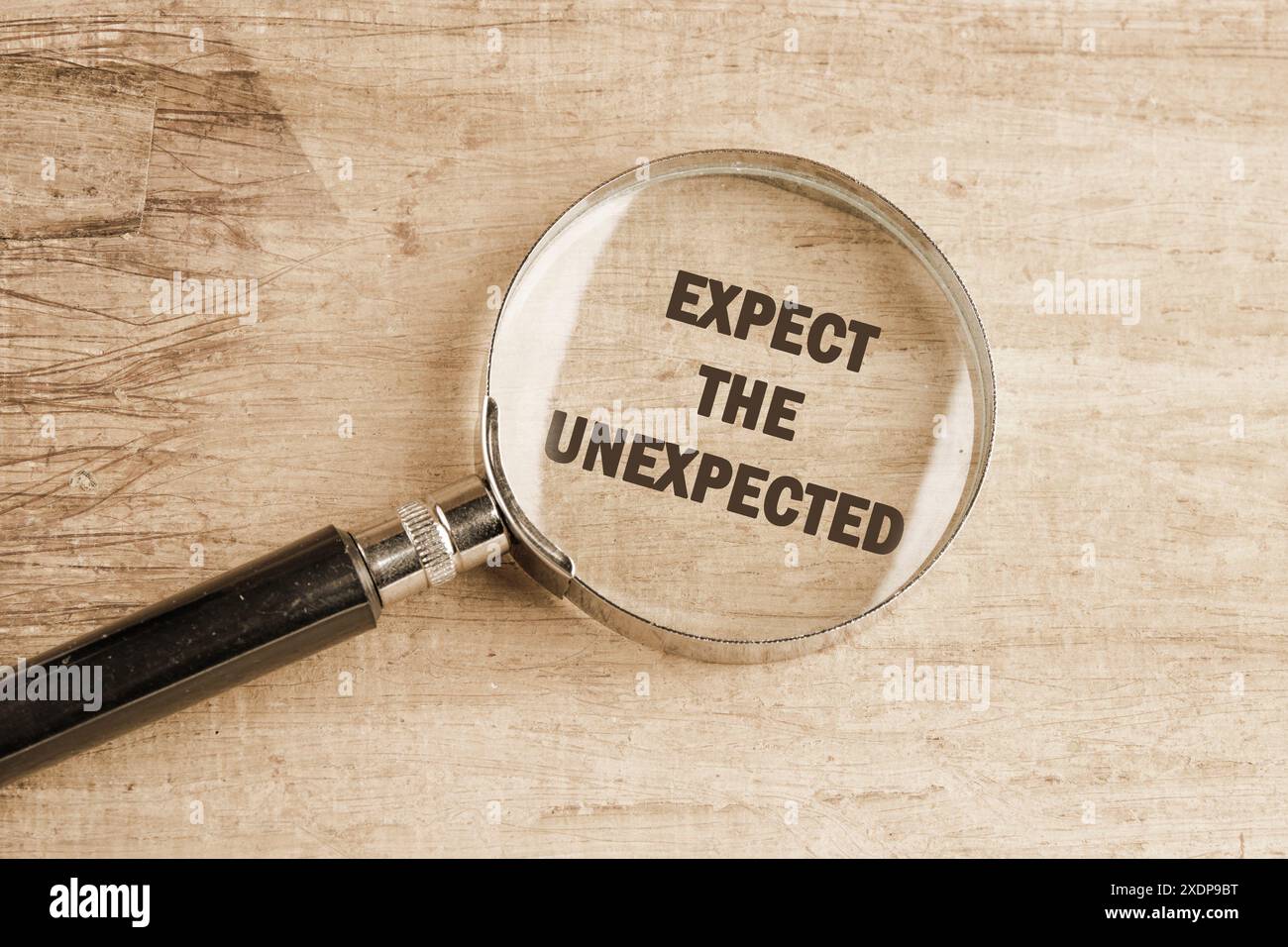 Expect the unexpected motivational phrase through a magnifying glass on ...