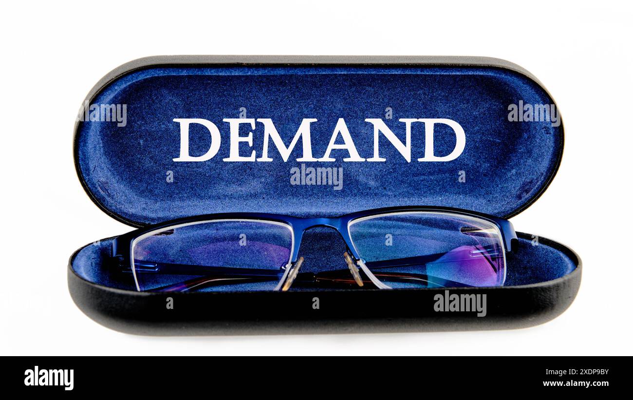Business concept. A Word DEMAND symbol on the inside of the glasses ...