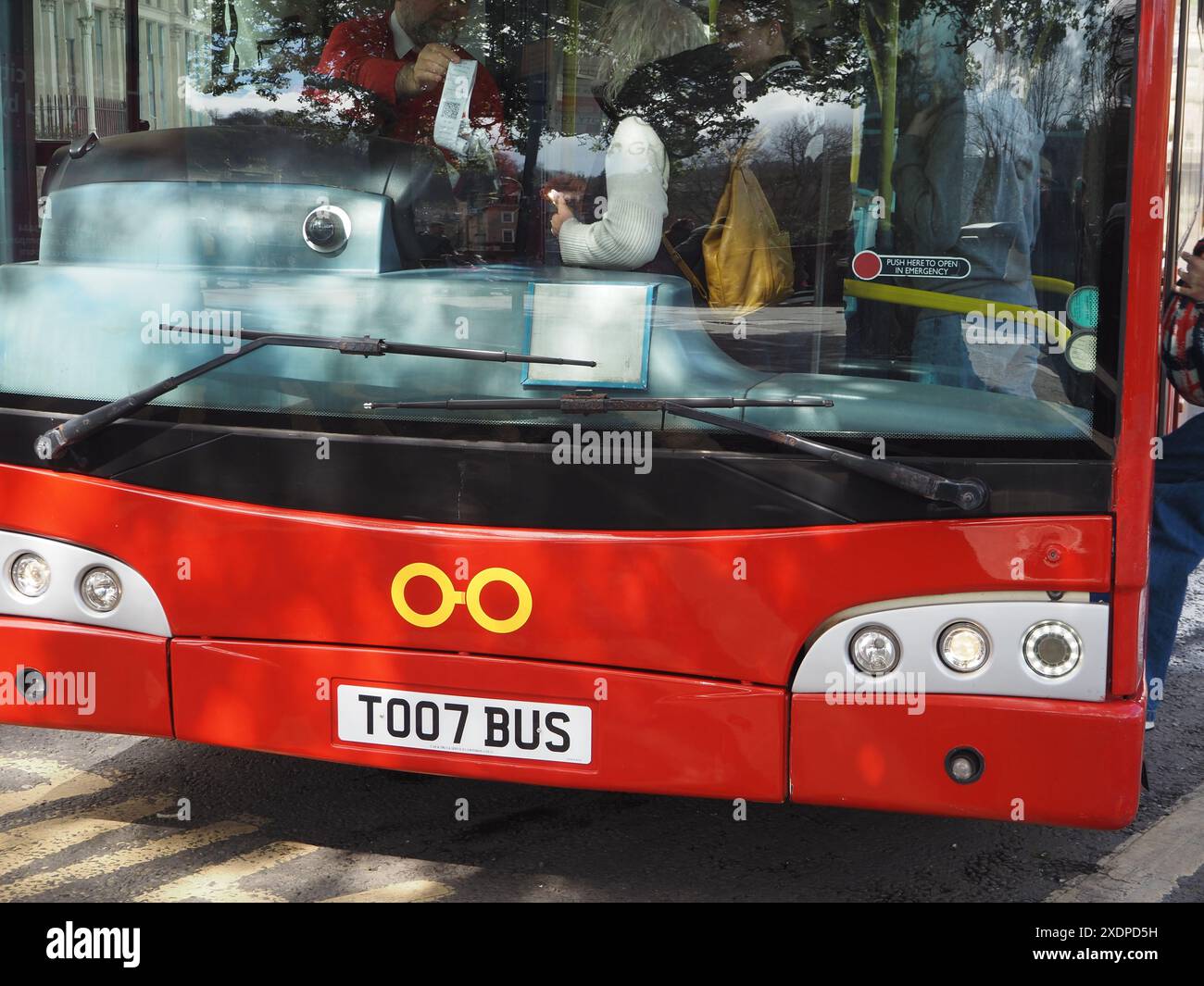 Front view of Toot Bus guided city tours bus as tourists board, with ...