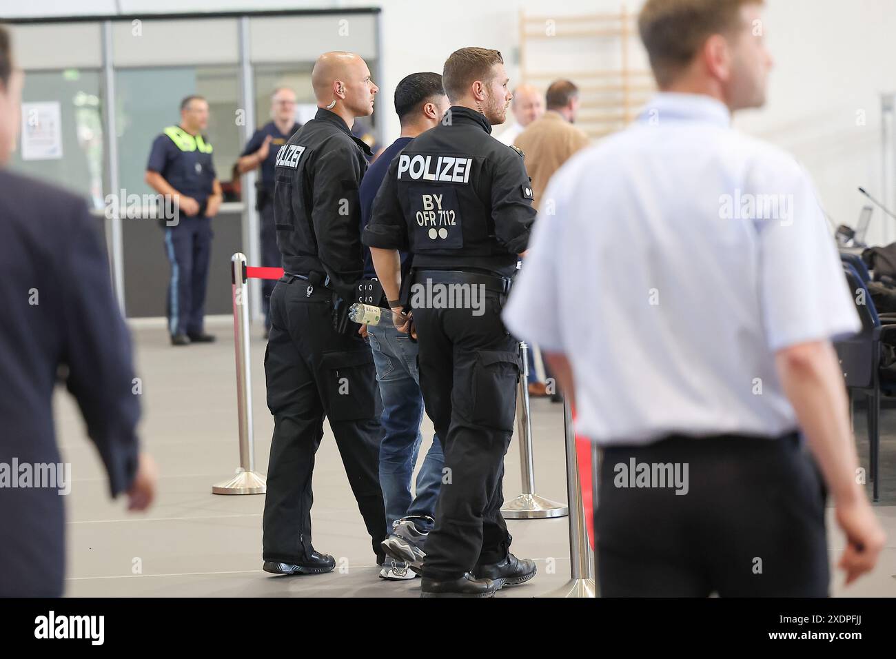 Bamberg, Germany. 24th June, 2024. A defendant is led into the John F ...