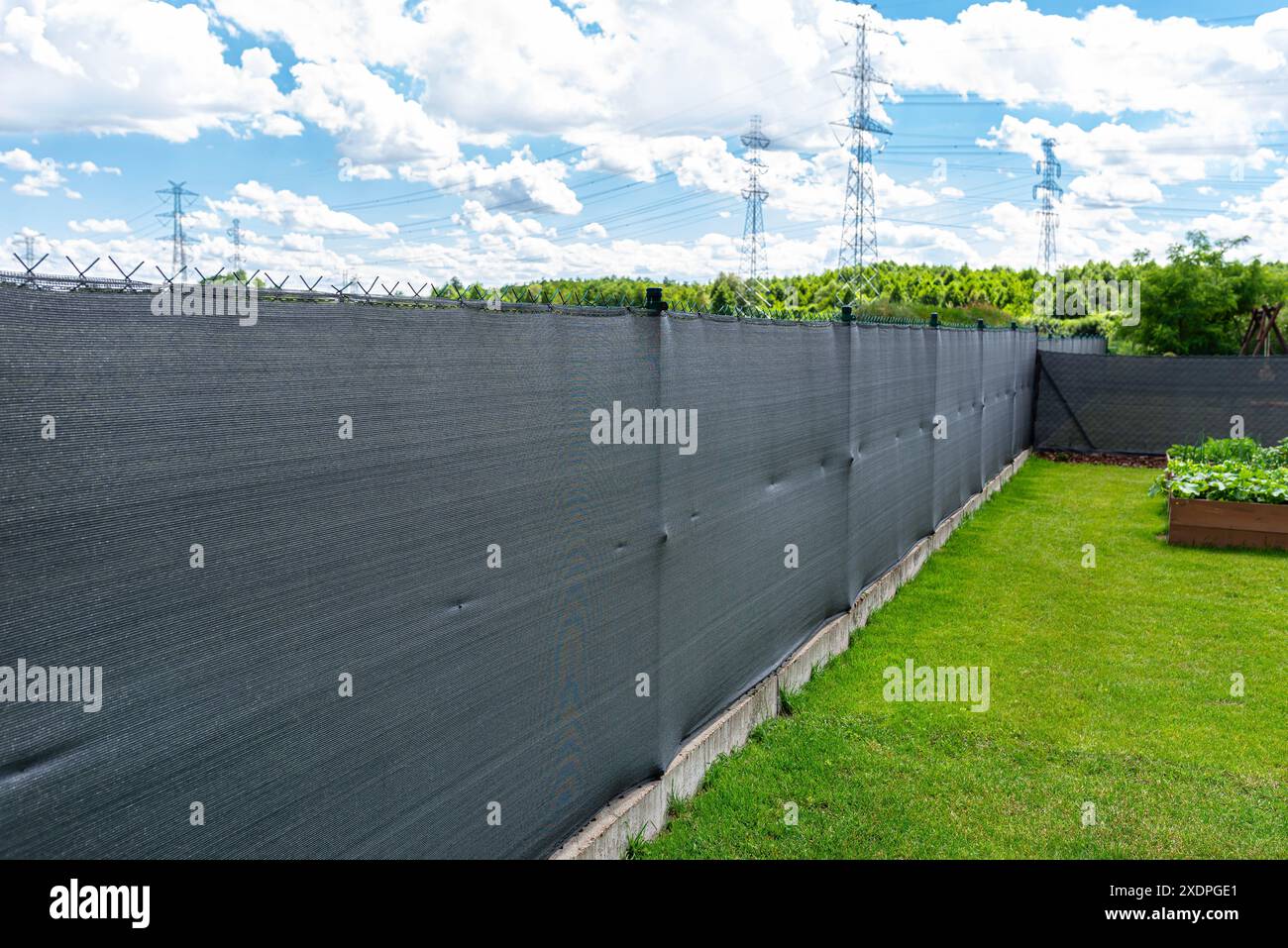 Anthracite-colored masking net placed on a mesh fence, visible ...