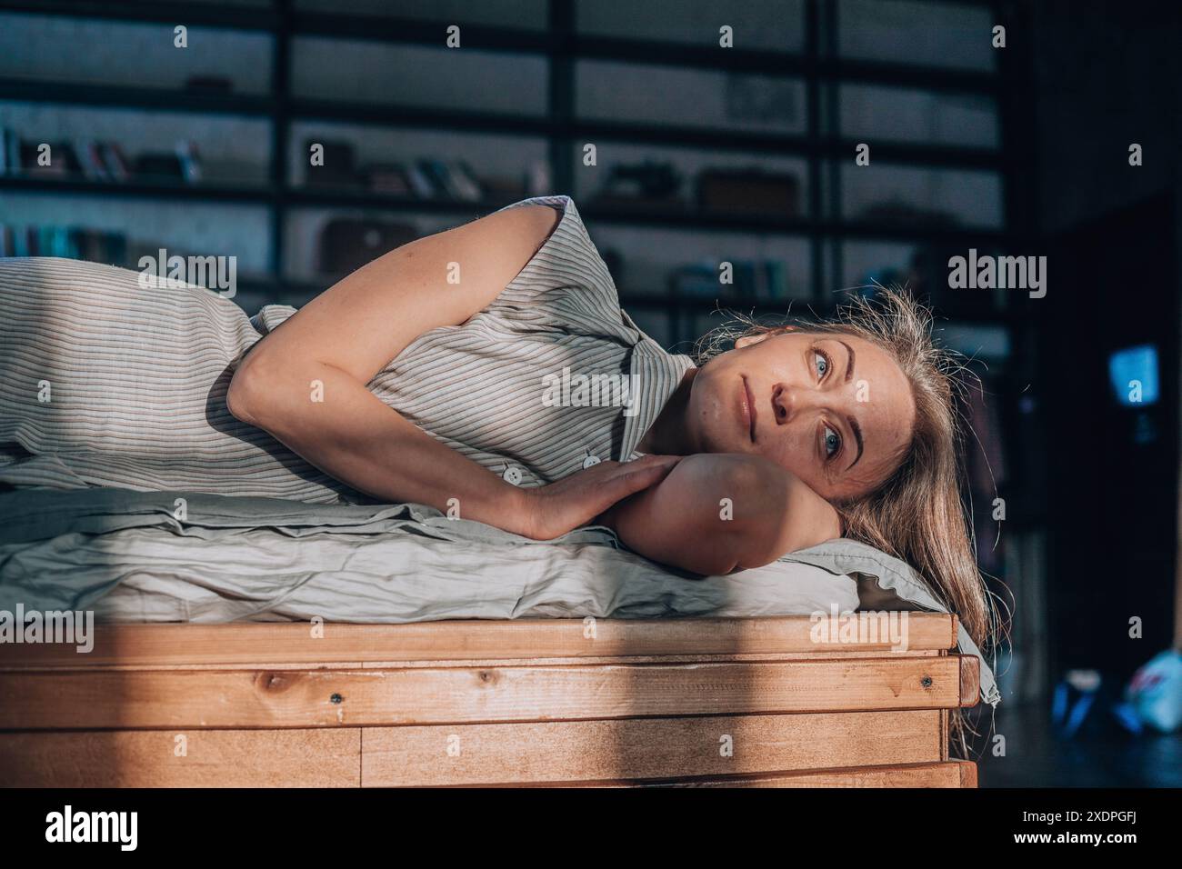 dreamy, thoughtful expression of the woman as she lies awake Stock ...