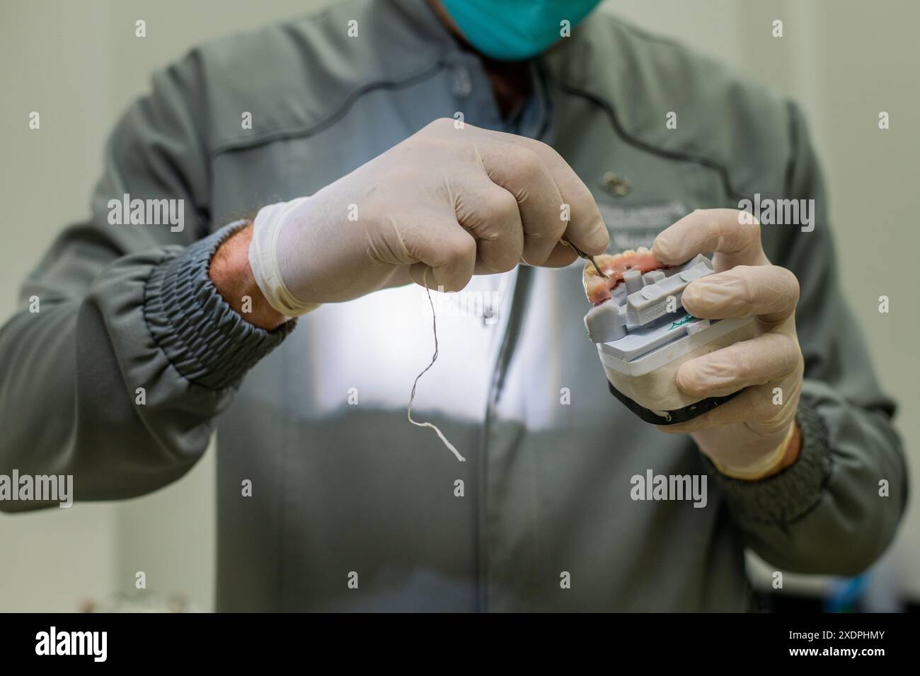 Dental surgeon working on prothesis for teeth replacement Stock Photo ...