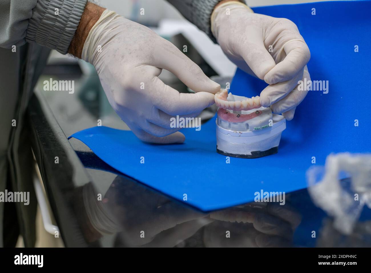 Dental surgeon working on prothesis for teeth replacement Stock Photo ...