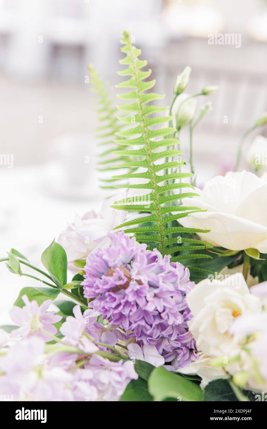 Floral arrangement with purple and white flowers and fer Stock Photo ...