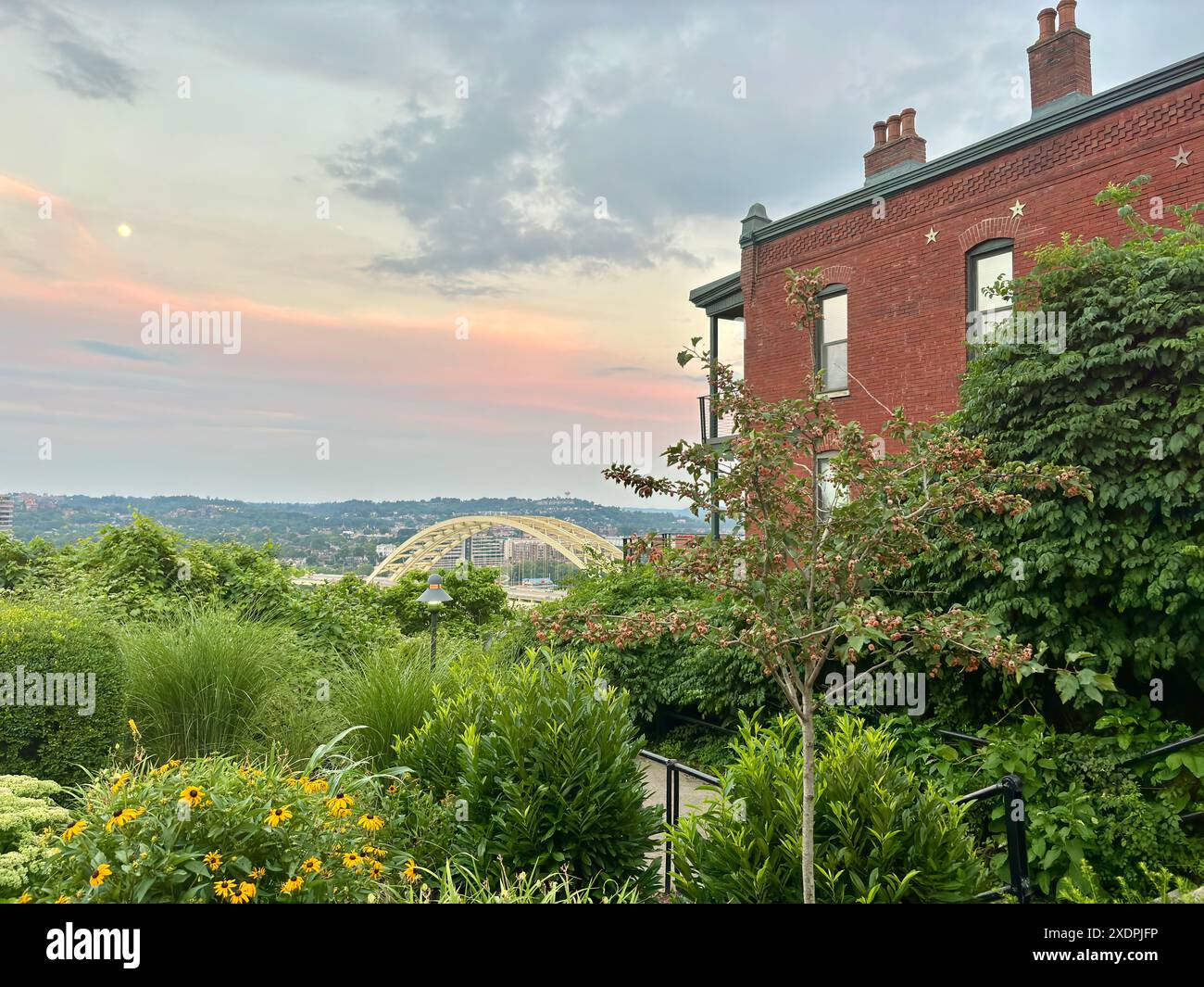 Sunset over Daniel Carter Beard Bridge, brick building in Cincinnati ...