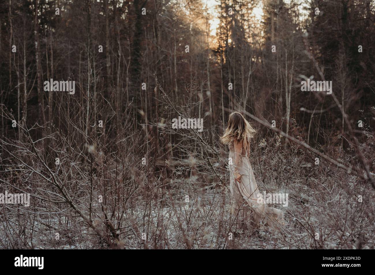 Woman in a dress twirling in the morning sun in nature Stock Photo - Alamy