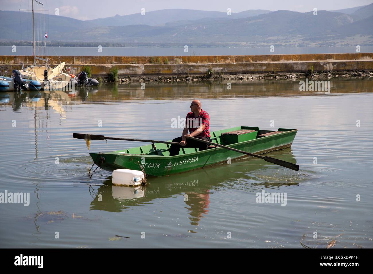 Golubac, Serbia, June 5, 2024: Man rowing in a tin boat at the Danube ...