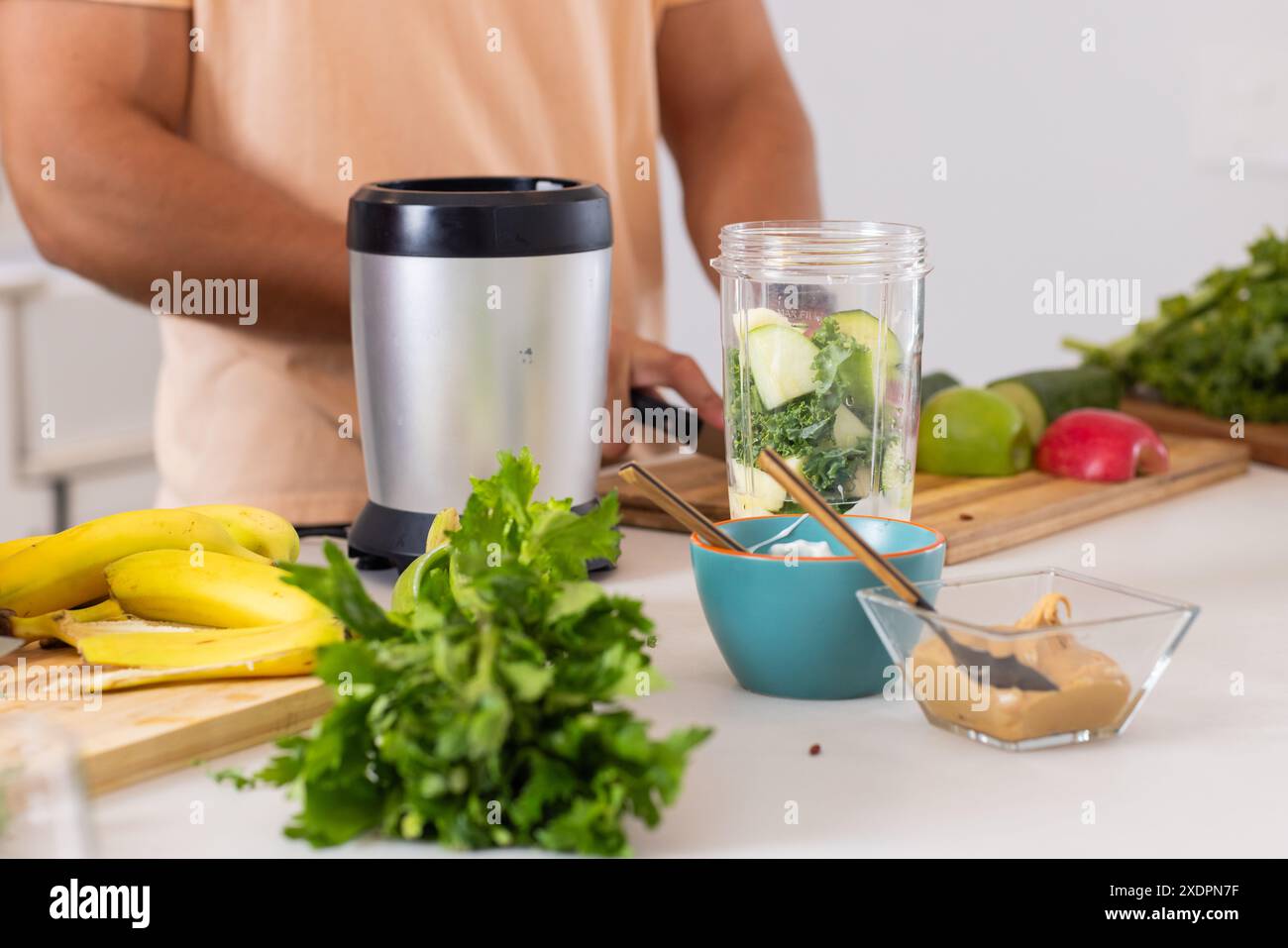 Preparing healthy smoothie, man blending fresh fruits and vegetables in ...