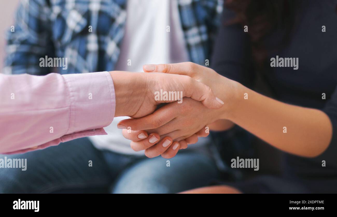 Close Up of Handshake Between Two People Sitting During Meeting Stock Photo - Alamy