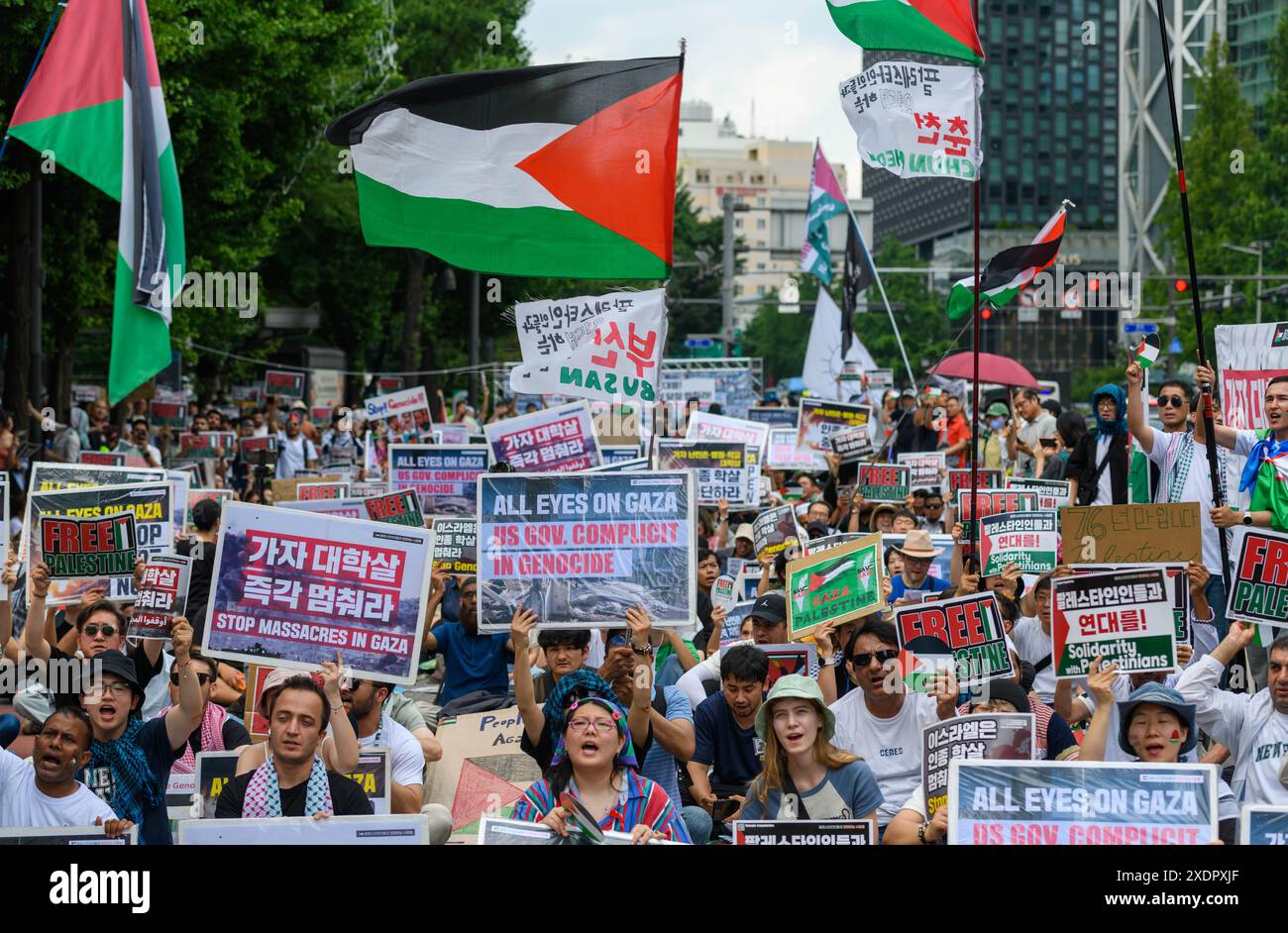 Protesters chant slogans and hold flags, placards expressing their ...
