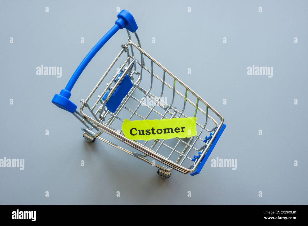 Shopping cart and piece of paper with word customer Stock Photo - Alamy