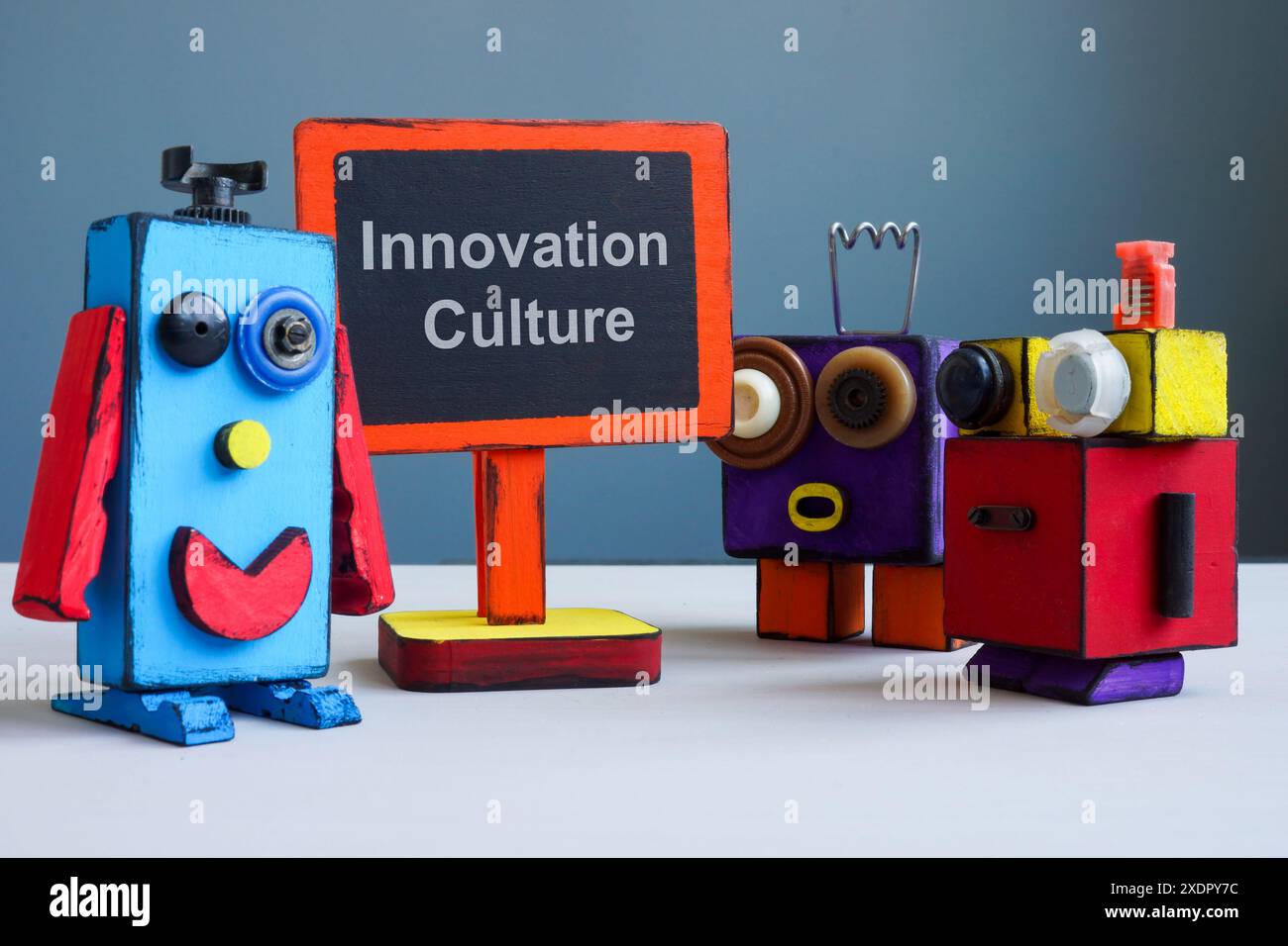 Funny robots and a board with an inscription Innovation culture Stock ...