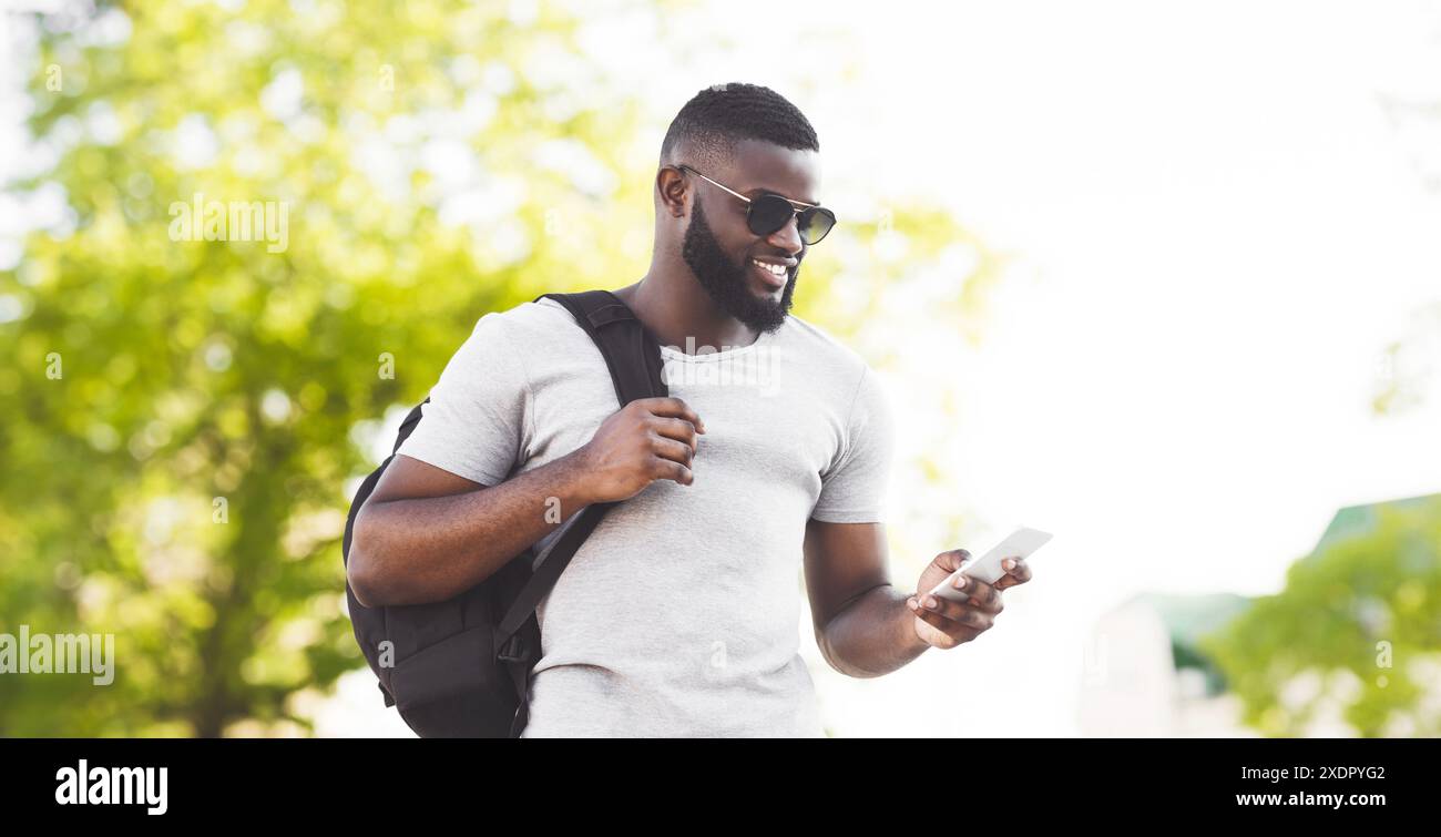 Happy man walking outdoors using hi-res stock photography and images ...