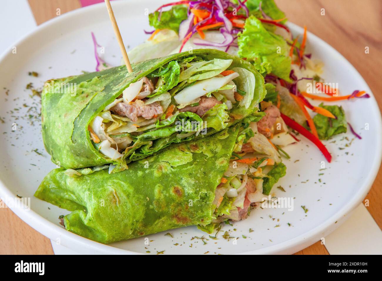 Healthy green wraps in a cafe environment served in a plate Stock Photo ...