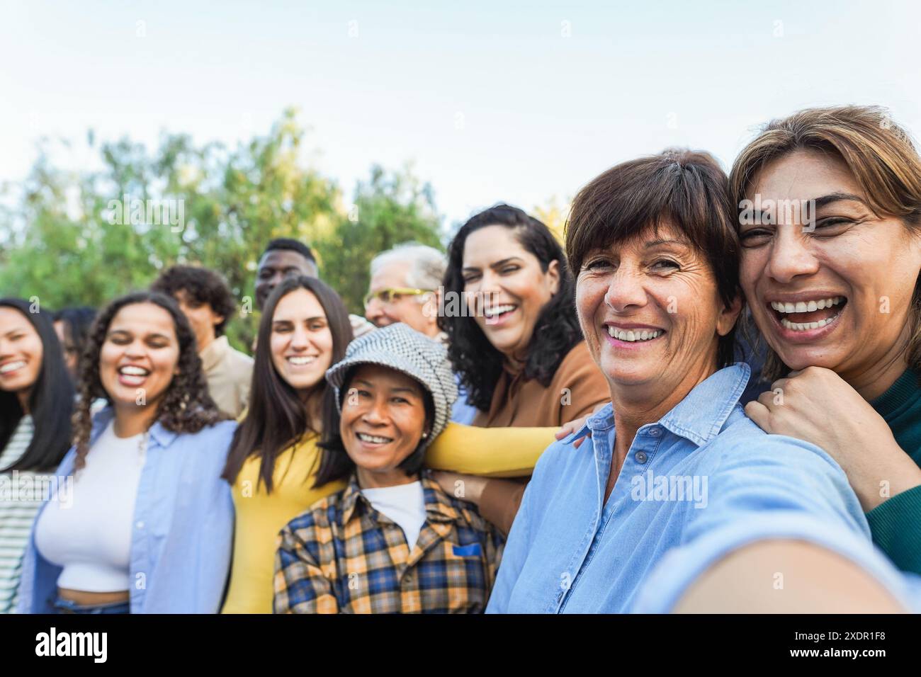 Group of multigenerational people taking selfie with phone camera - Multiracial friends of ...