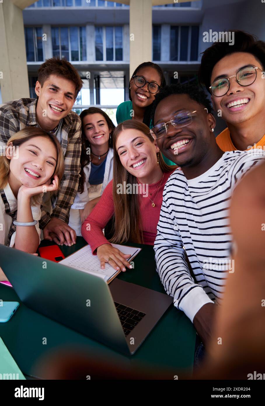 Happy selfie of a multiracial group of student friends gathered at ...