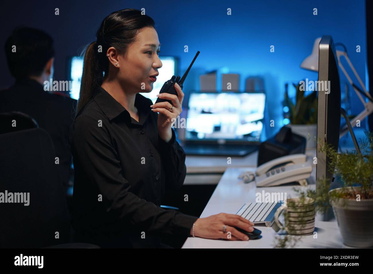 Security Worker Talking By Radio In Security Room Stock Photo - Alamy