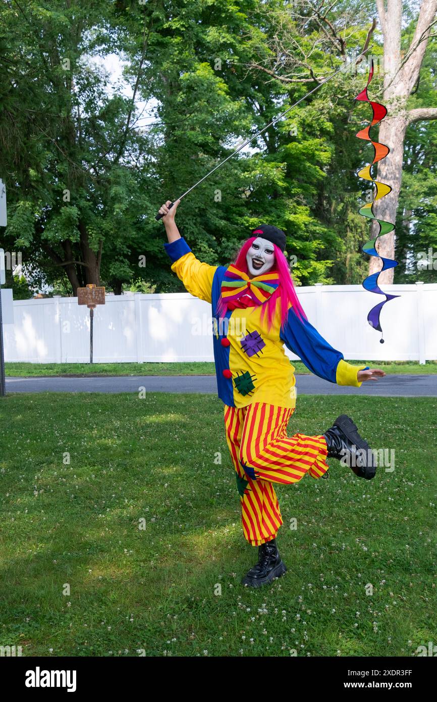 Posed photo of a drag performance artist in a colorful clown costume ...
