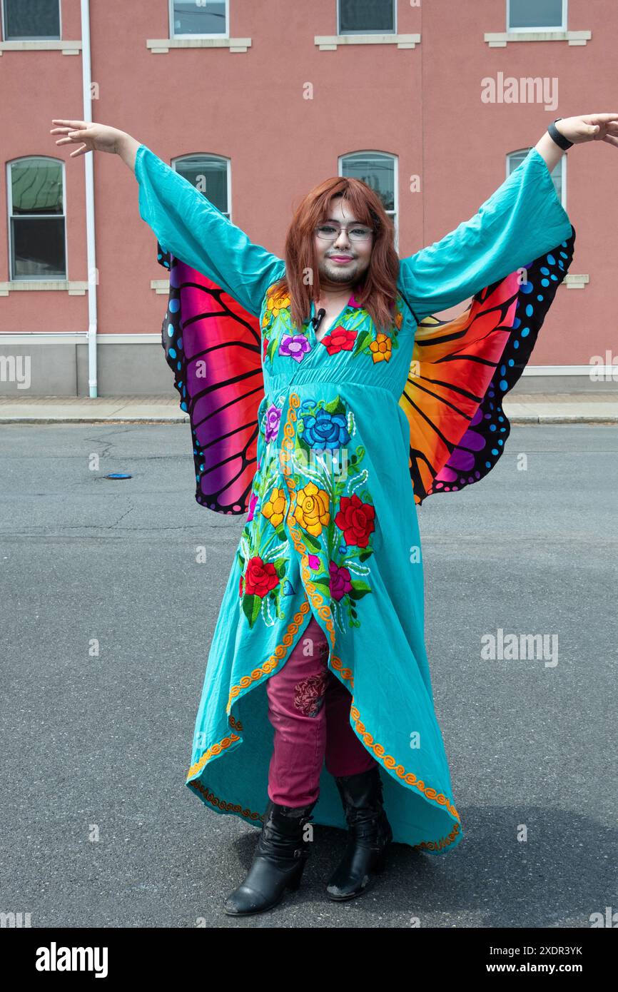 A man in drag with a red hair wig and a butterfly dress. At the 2024 ...