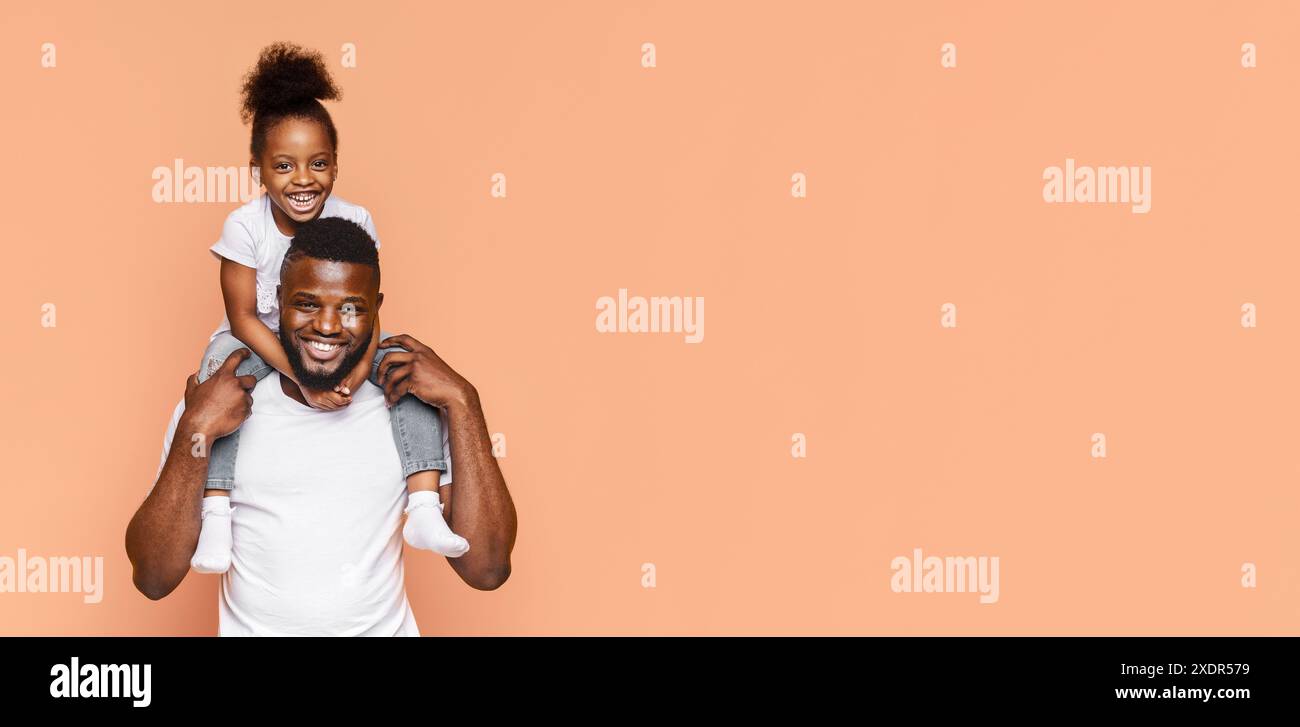 Happy Black Father And Daughter Pose For Photo On Peach Stock Photo - Alamy