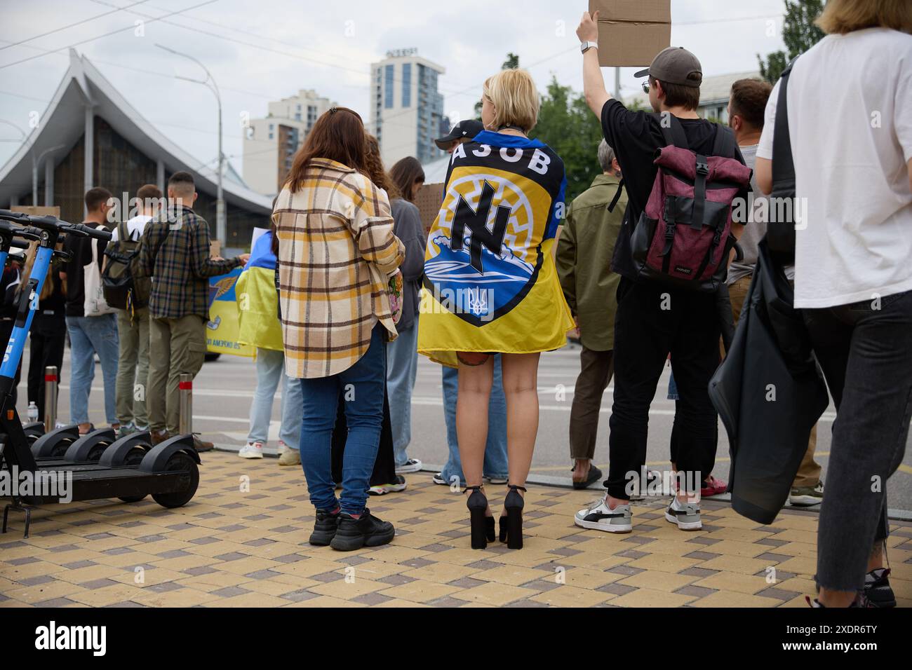 Ukrainian girl wearing a flag of Azov brigade on her shoulders at a ...