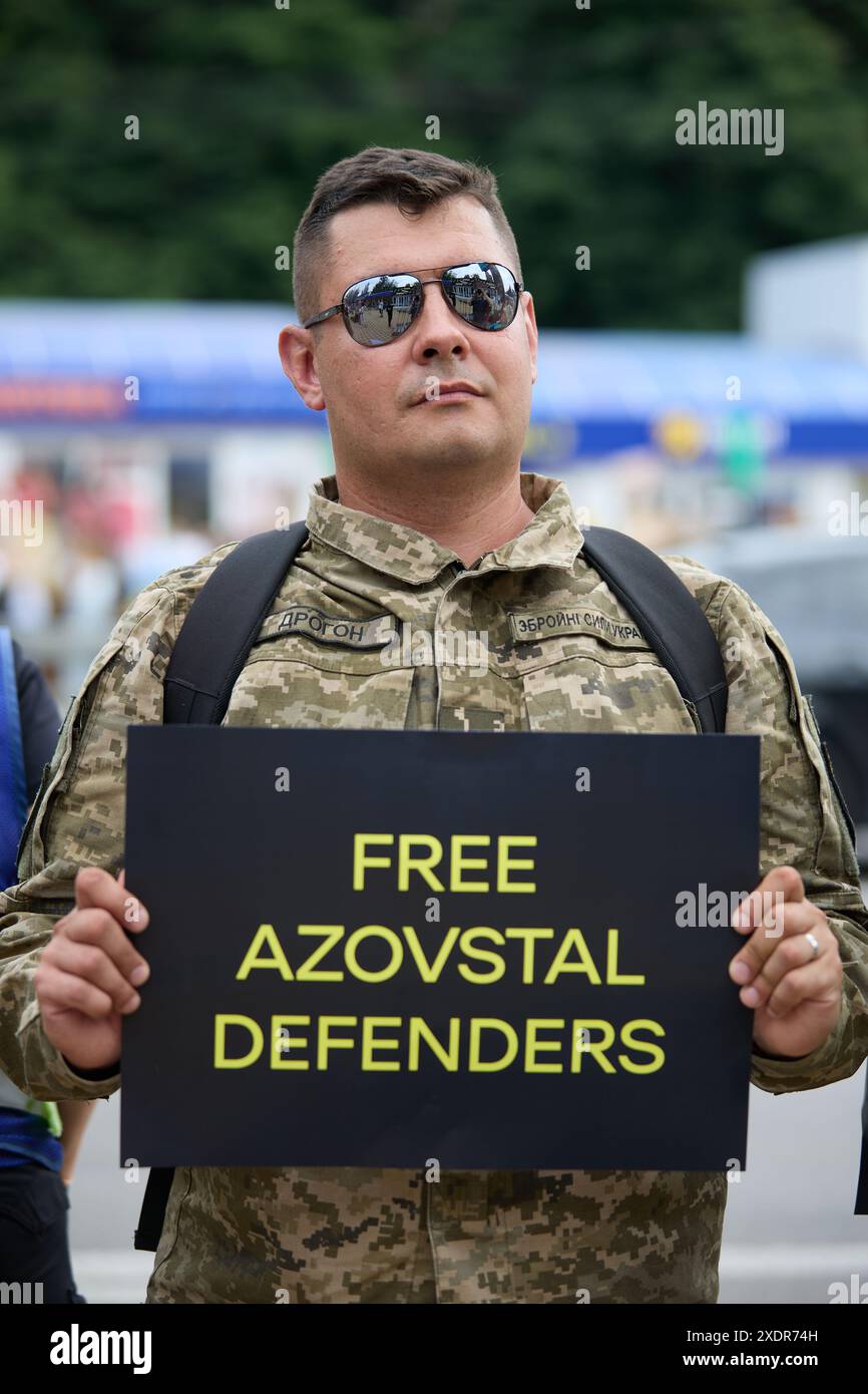 Ukrainian LGBT battalion soldier posing with a banner "Free Azovstal ...