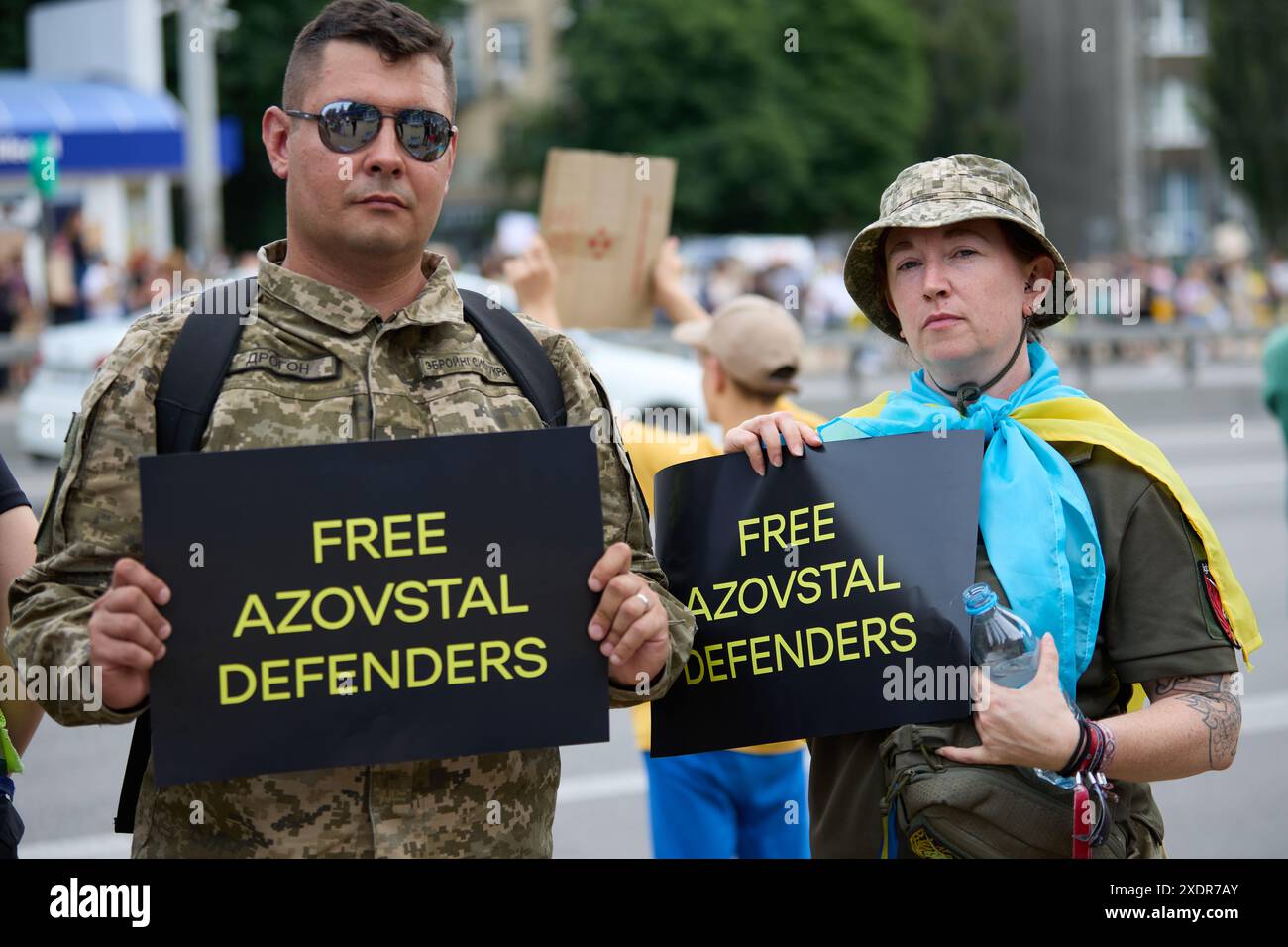 Ukrainian LGBT soldiers posing with signs "Free Azovstal Defenders" on ...