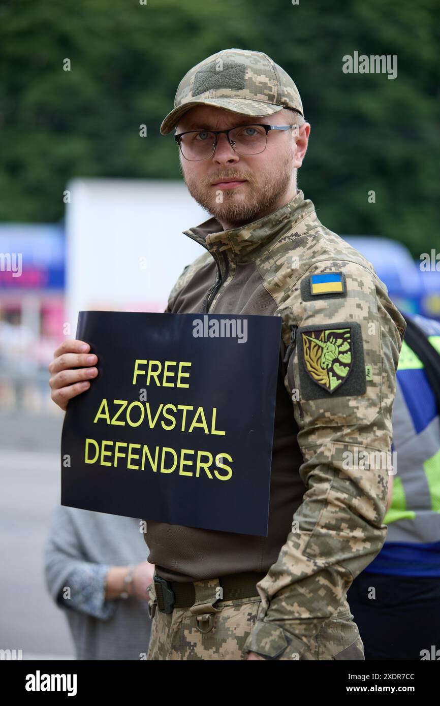 Ukrainian soldier from LGBT unit posing with a sign "Free Azovstal ...