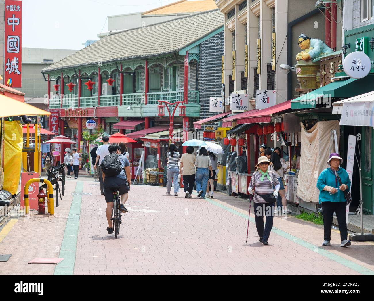 People walk along the Chinatown street in Incheon. Incheon Chinatown ...