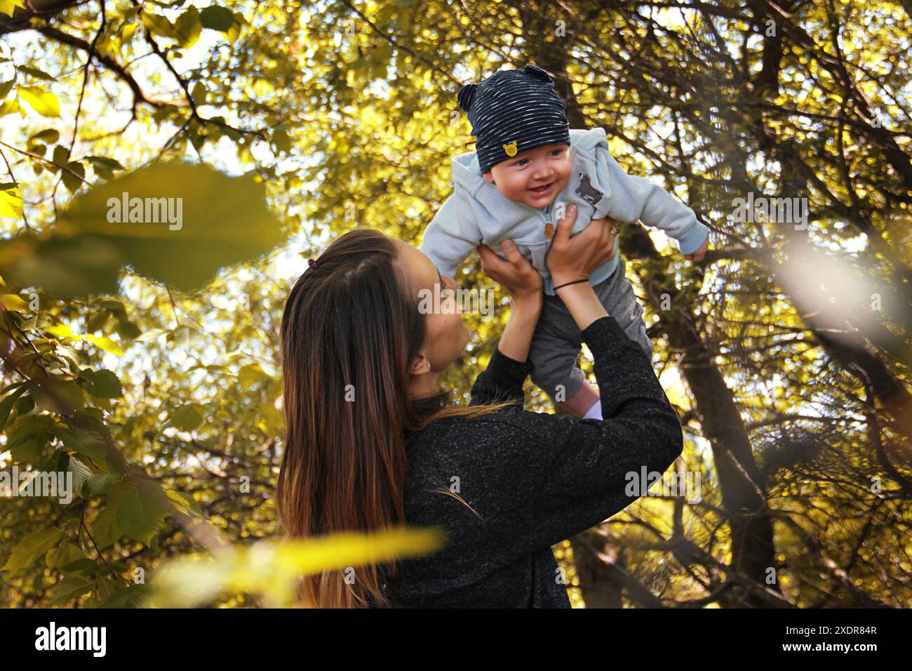 Mother holding her son in her arms Stock Photo - Alamy