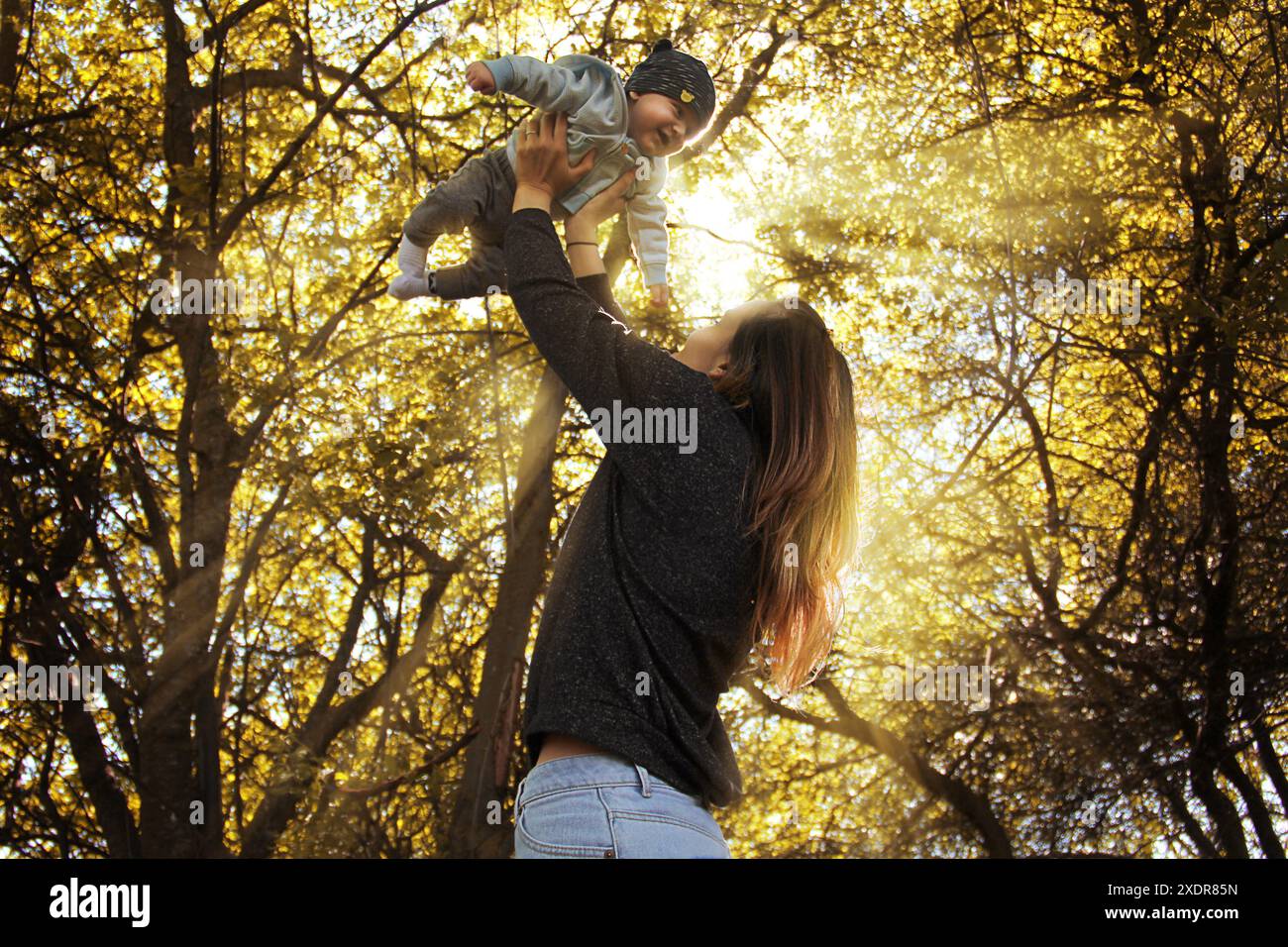 Mother holding her son in her arms Stock Photo - Alamy