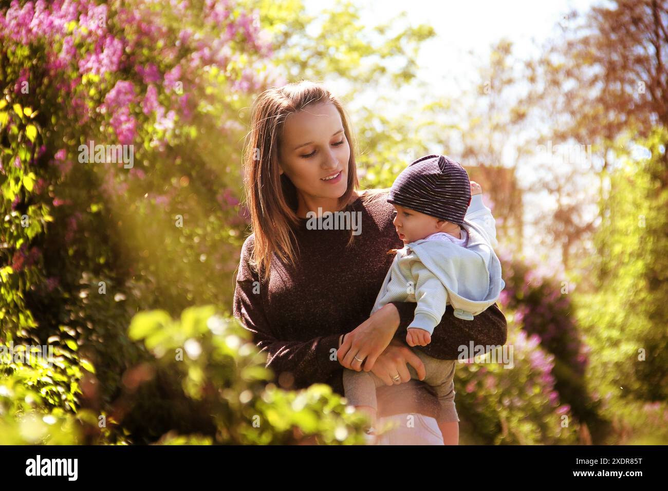 Woman holds child arms hi-res stock photography and images - Alamy