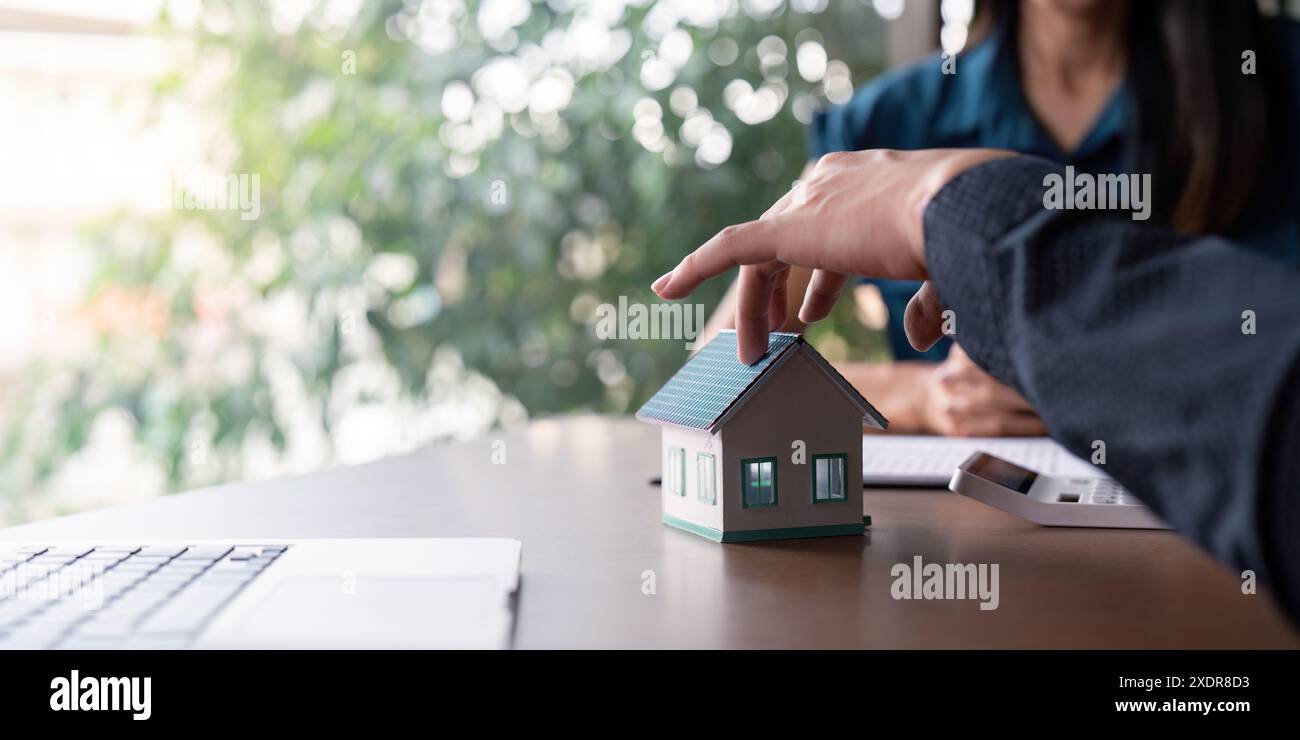 Real Estate Agent Buy Sell Contract with Hands Signing Agreement and Model House on Desk Stock ...