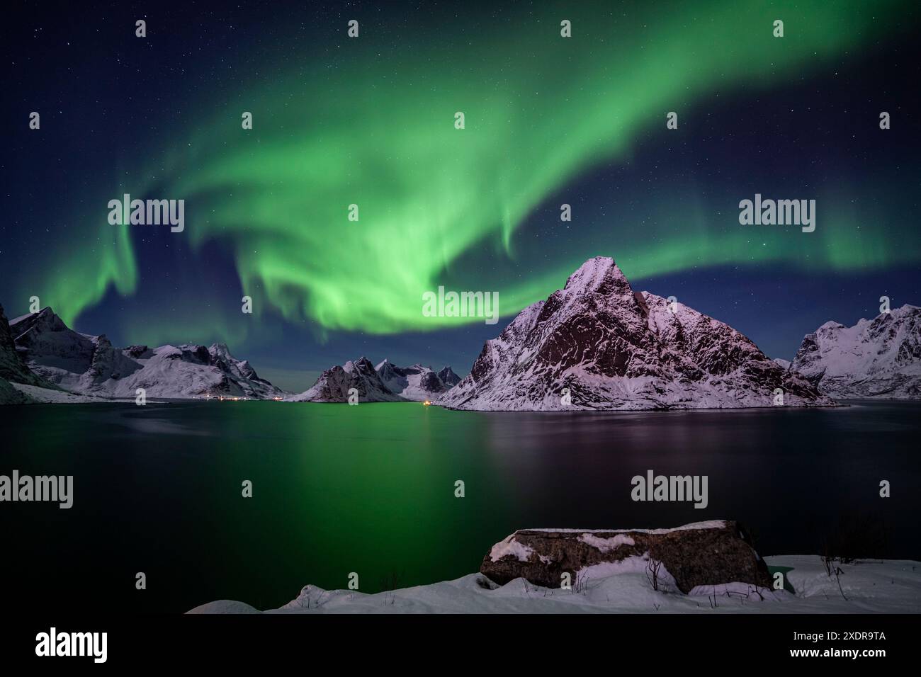 Northern lights over a fjord an steep mountains, Aurora borealis, Reine ...