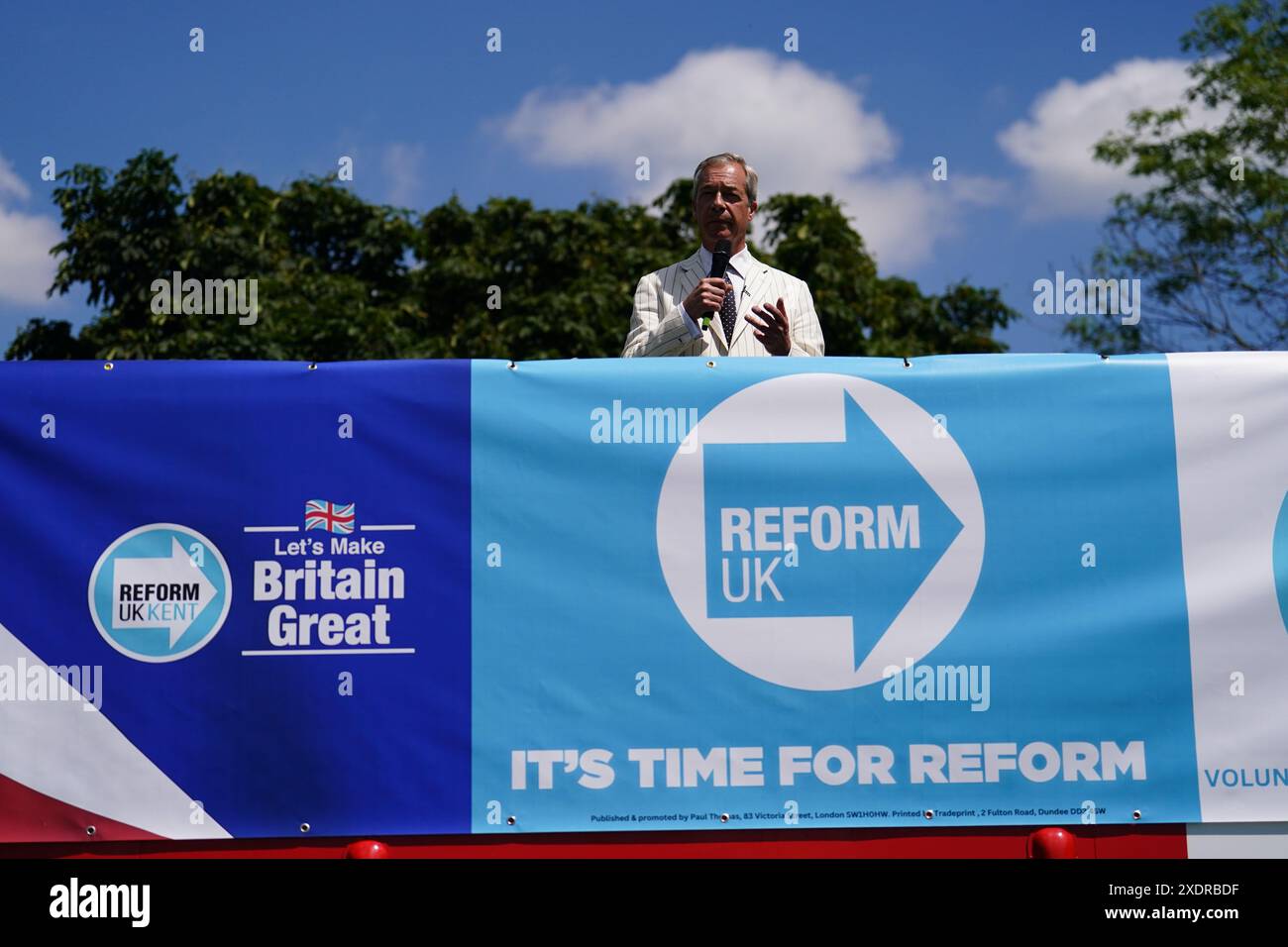 Reform UK leader Nigel Farage speaking on top of a double decker bus at the Mercure Maidstone ...