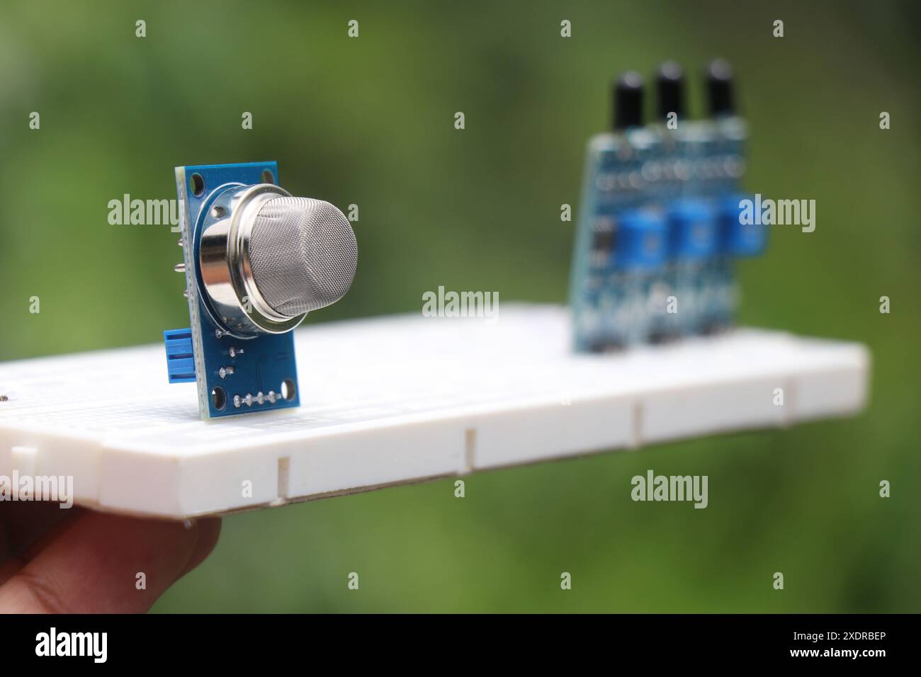 Gas sensor on a breadboard that is used to detect the leakage of LPG ...