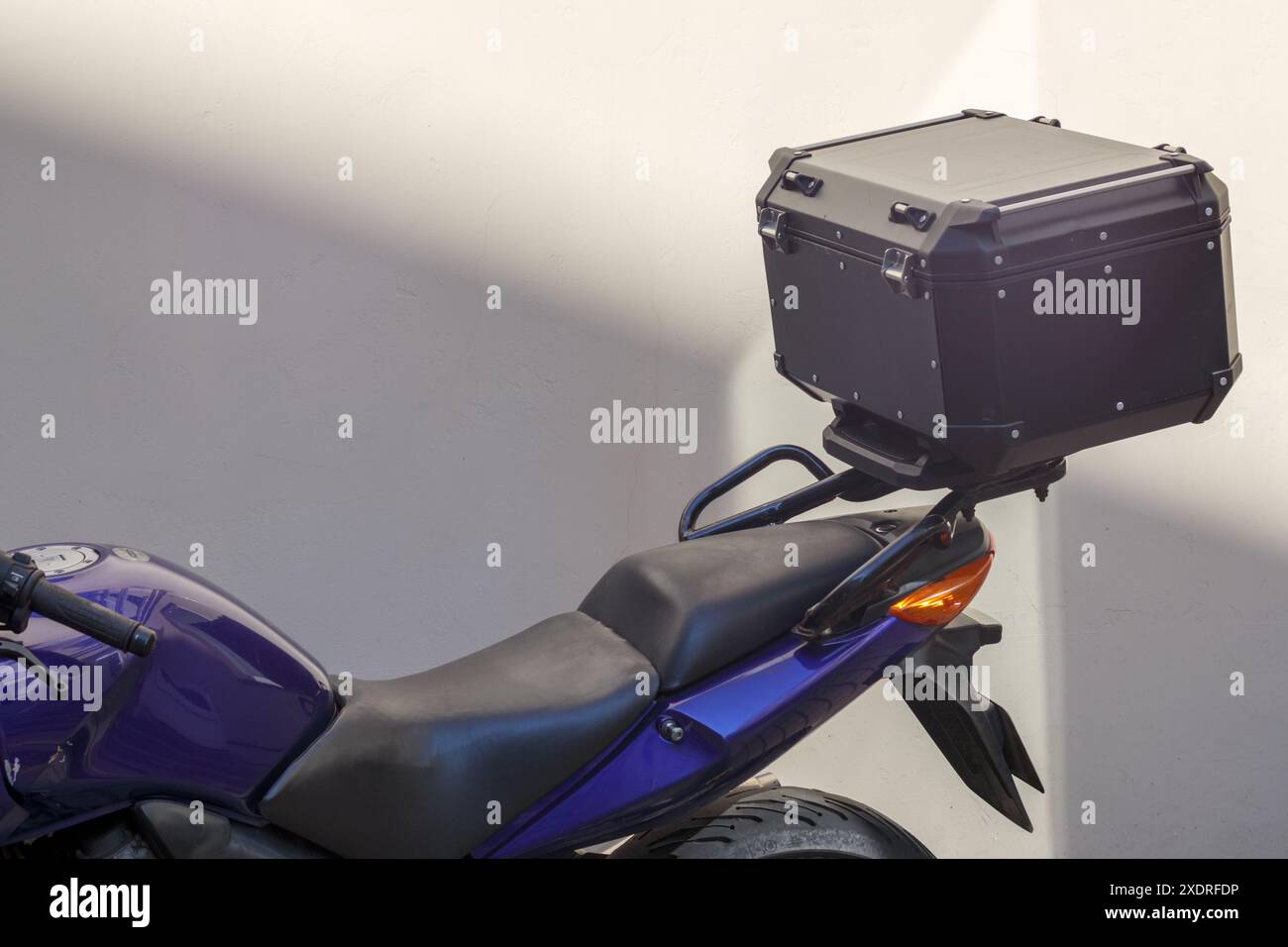 Motorcycle with square black luggage bag Stock Photo - Alamy