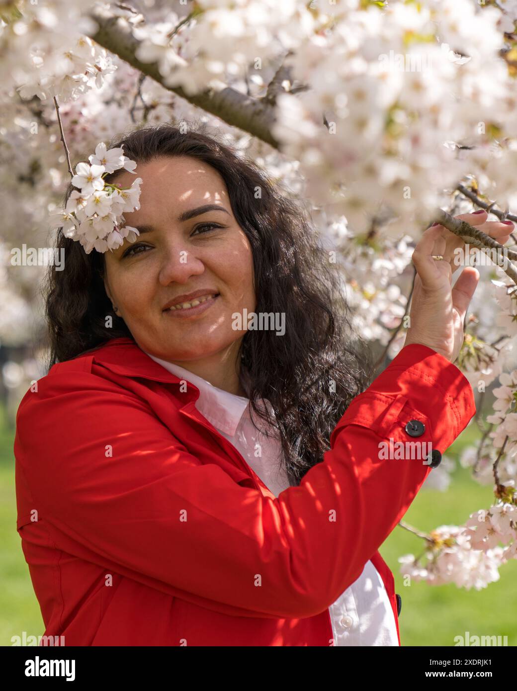 romantic image of a stylish woman in a red coat and white blouse ...