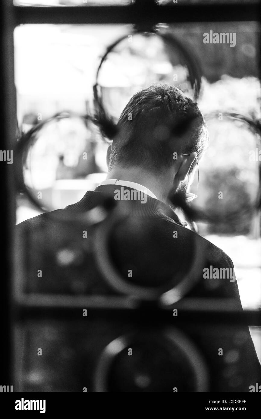 Priest in the window of the Basilica Notre-Dame de la Victoire, in ...