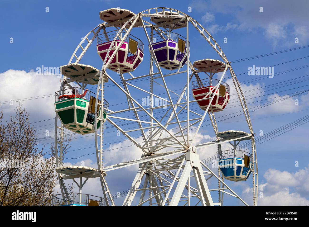 colorful children's ferris wheel on blue sky Stock Photo - Alamy