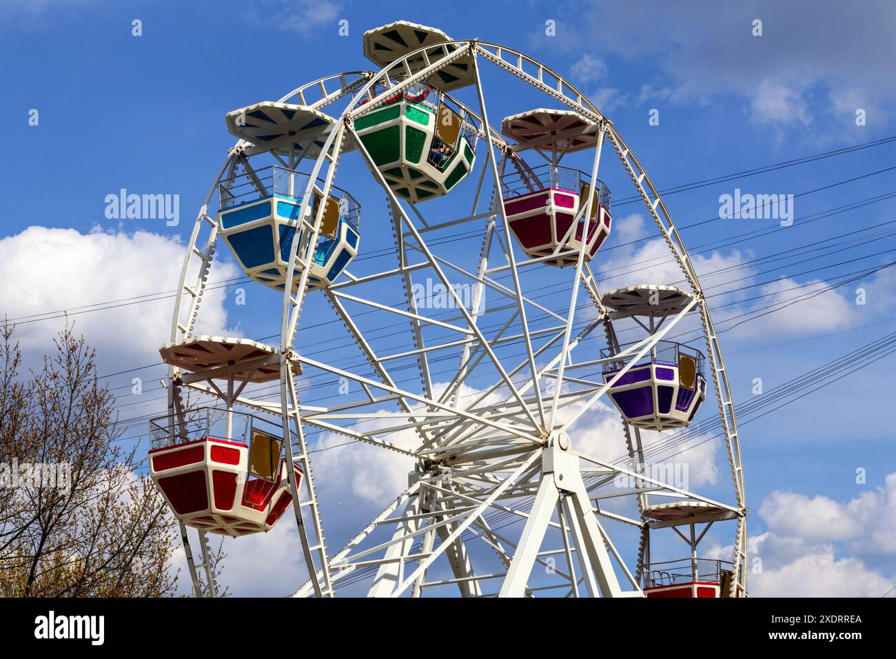 colorful children's ferris wheel on blue sky Stock Photo - Alamy