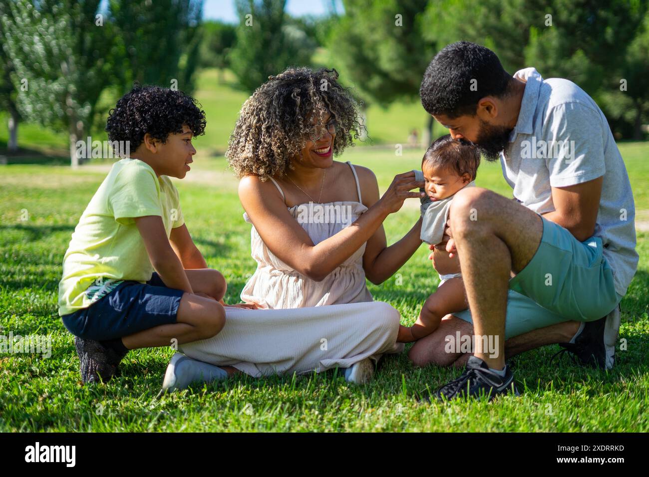 Latin family of mother, father, 7 year old son and baby together in a ...